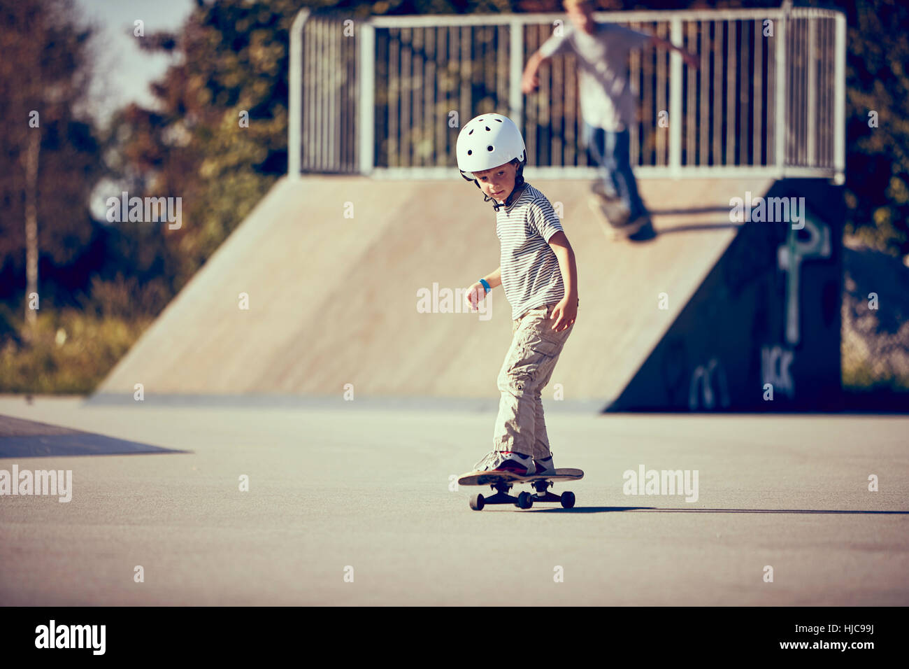 Boy skateboarding in park Stock Photo - Alamy