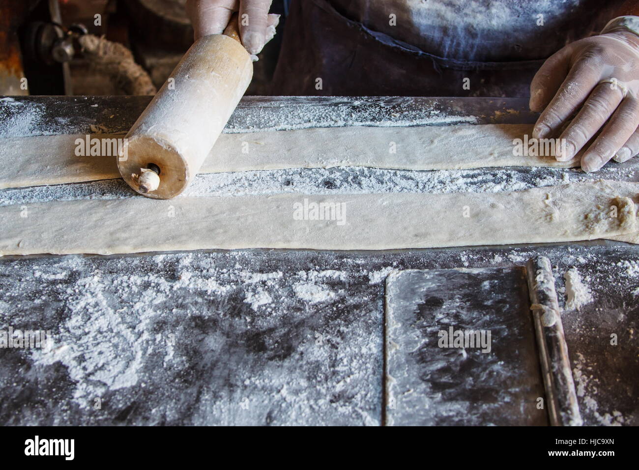 Female cook rolling dough with rolling-pin. Closeup view Stock Photo ...