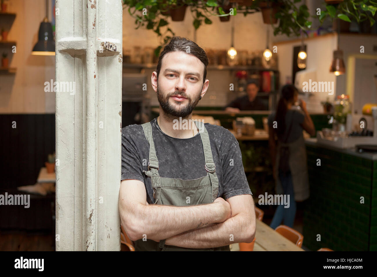 Portrait of young male cafe owner in cafe Stock Photo - Alamy
