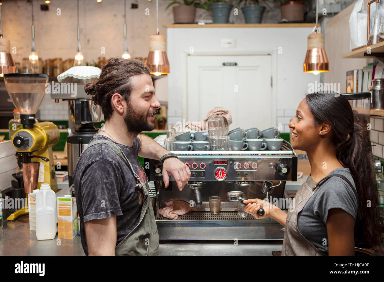 Two female baristas talking hi-res stock photography and images - Alamy