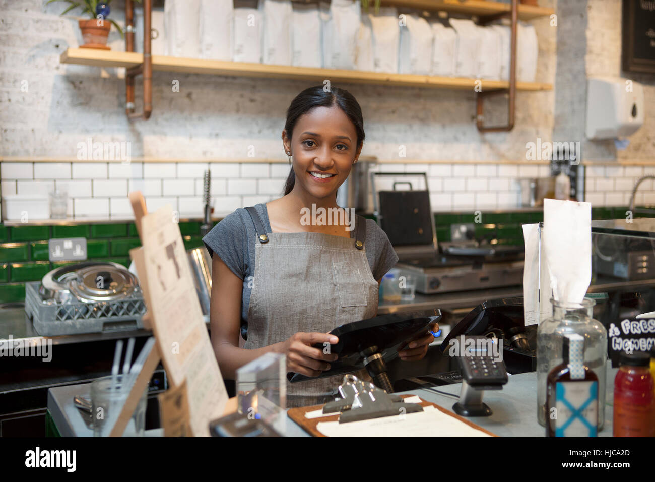 Portrait of female barista in cafe kitchen Stock Photo - Alamy