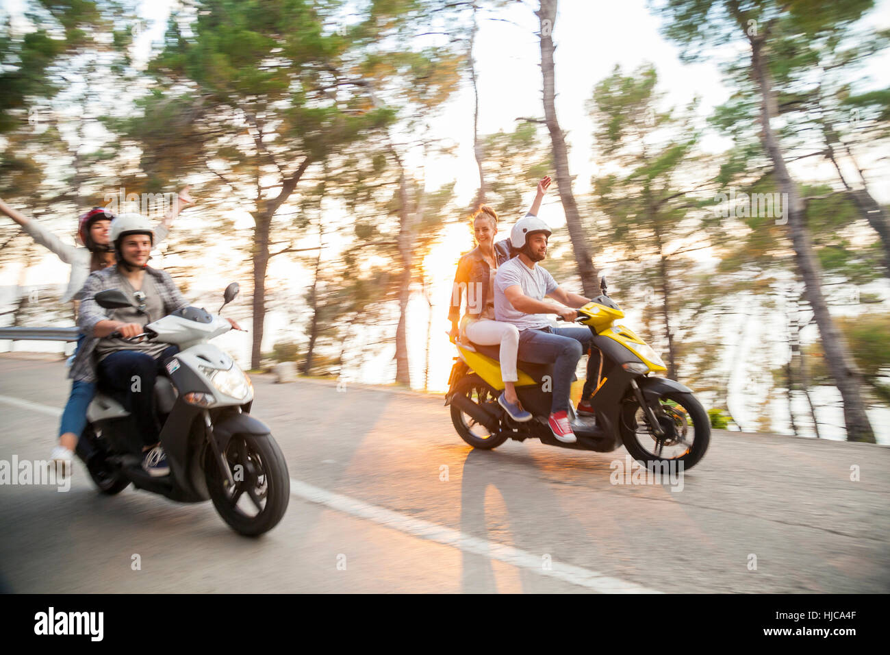 Two couples riding mopeds along coastal road, Split, Dalmatia, Croatia ...