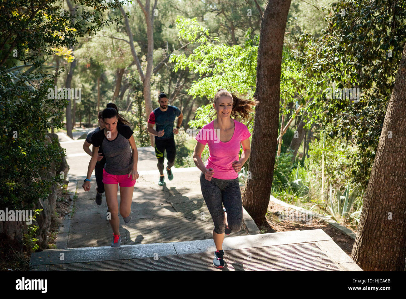 Four male and female runners running in park, Split, Dalmatia, Croatia ...