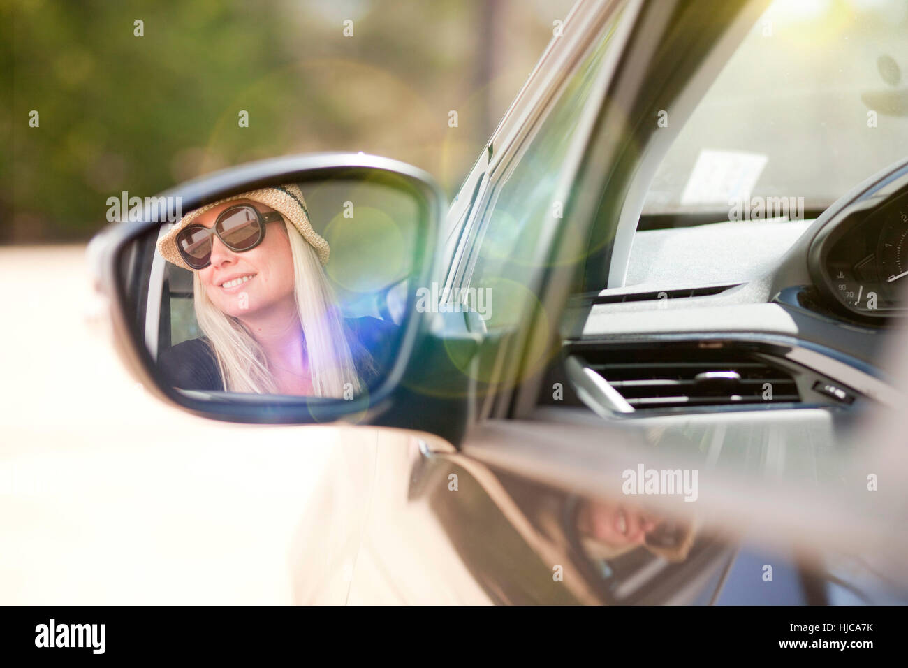 Woman looking out of car window Stock Photo - Alamy