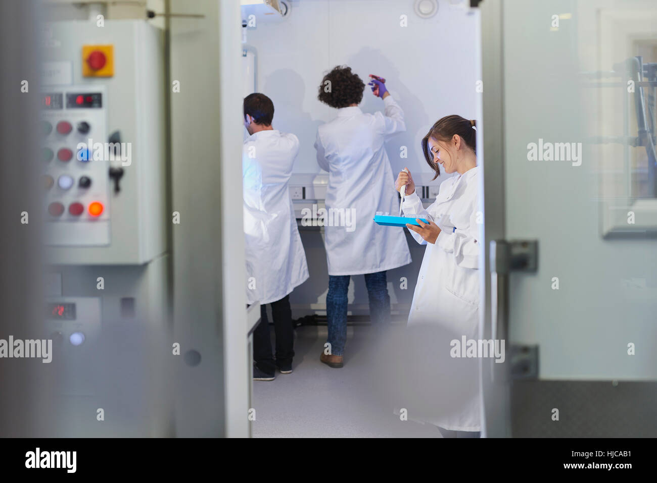 View through doorway of scientists in laboratory Stock Photo - Alamy