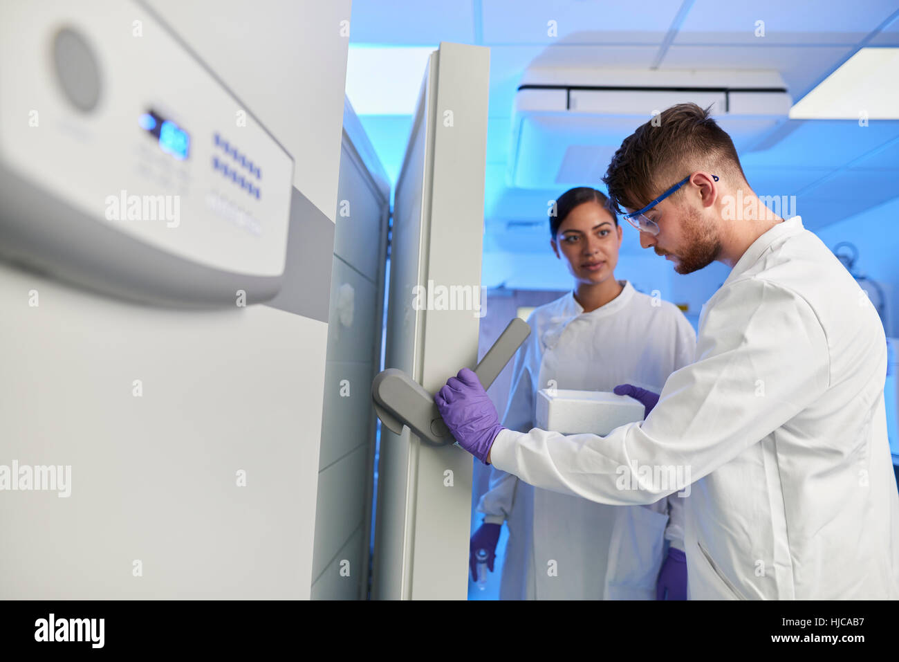 Scientists in laboratory using scientific equipment Stock Photo - Alamy