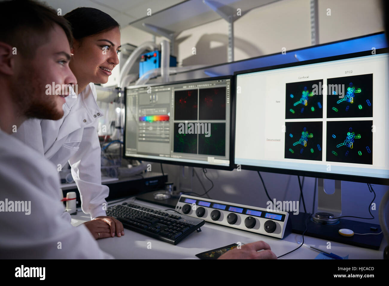 Scientists in laboratory using computer Stock Photo - Alamy