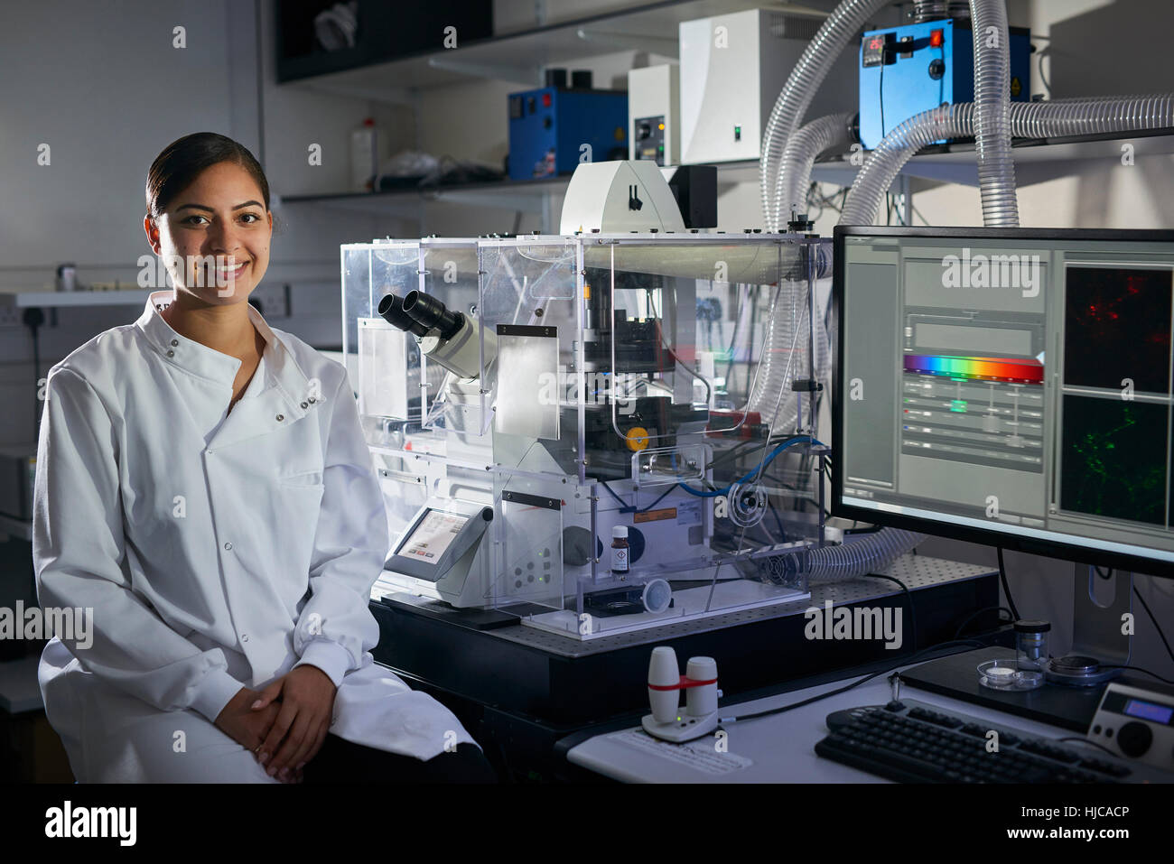 Portrait of scientist in laboratory looking at camera smiling Stock ...