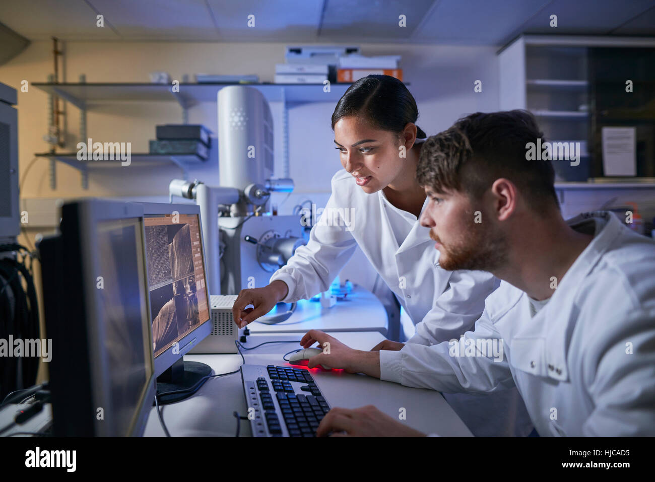 Scientists in laboratory using computer Stock Photo - Alamy