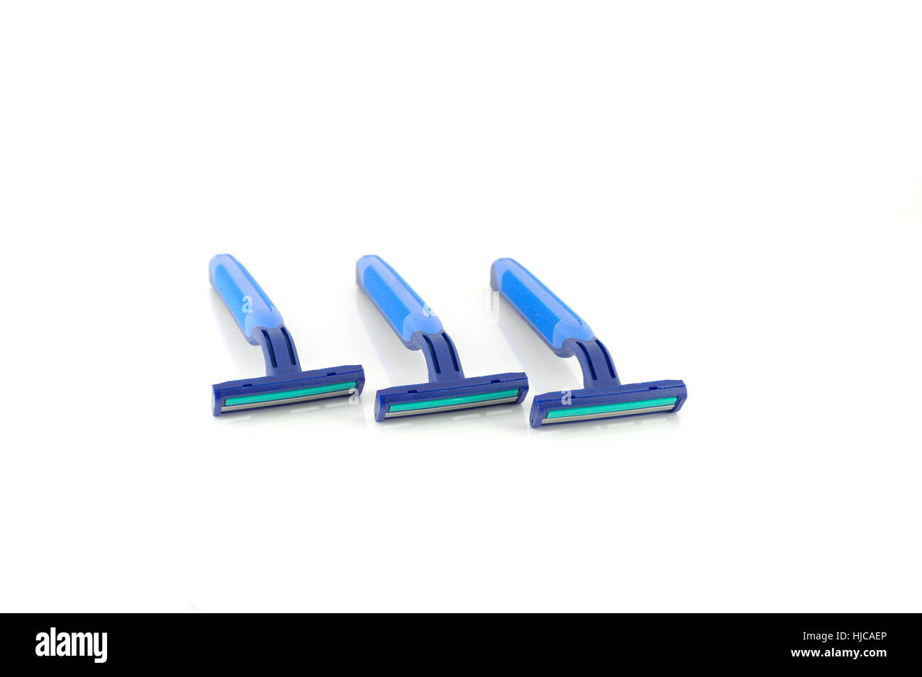Three blue razors over white Stock Photo - Alamy