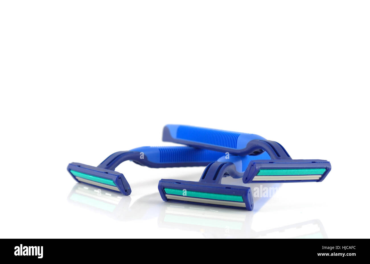 Three blue razors over white. Shallow DOF Stock Photo - Alamy