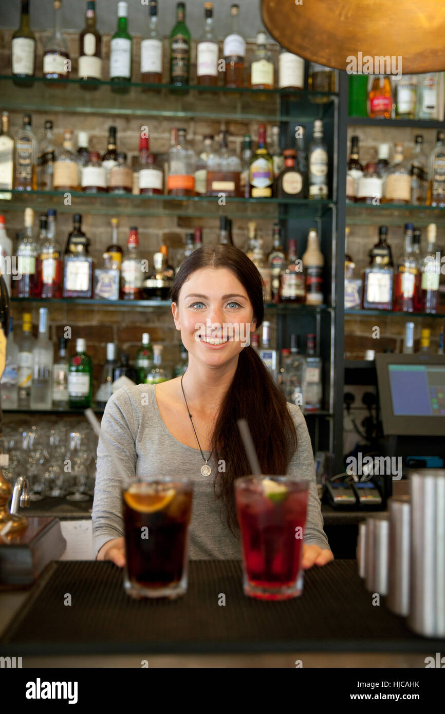 Bartender serving drinks in pub, London Stock Photo - Alamy