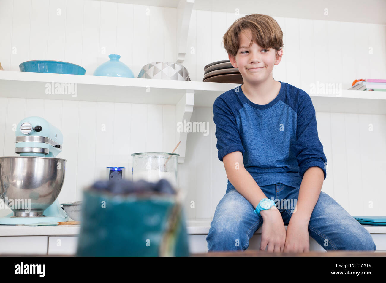 Boy sitting on counter hi-res stock photography and images - Alamy