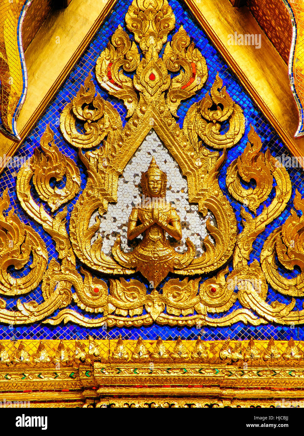 Gold carvings of celestial deities on the walls of kings palace Bangkok ...