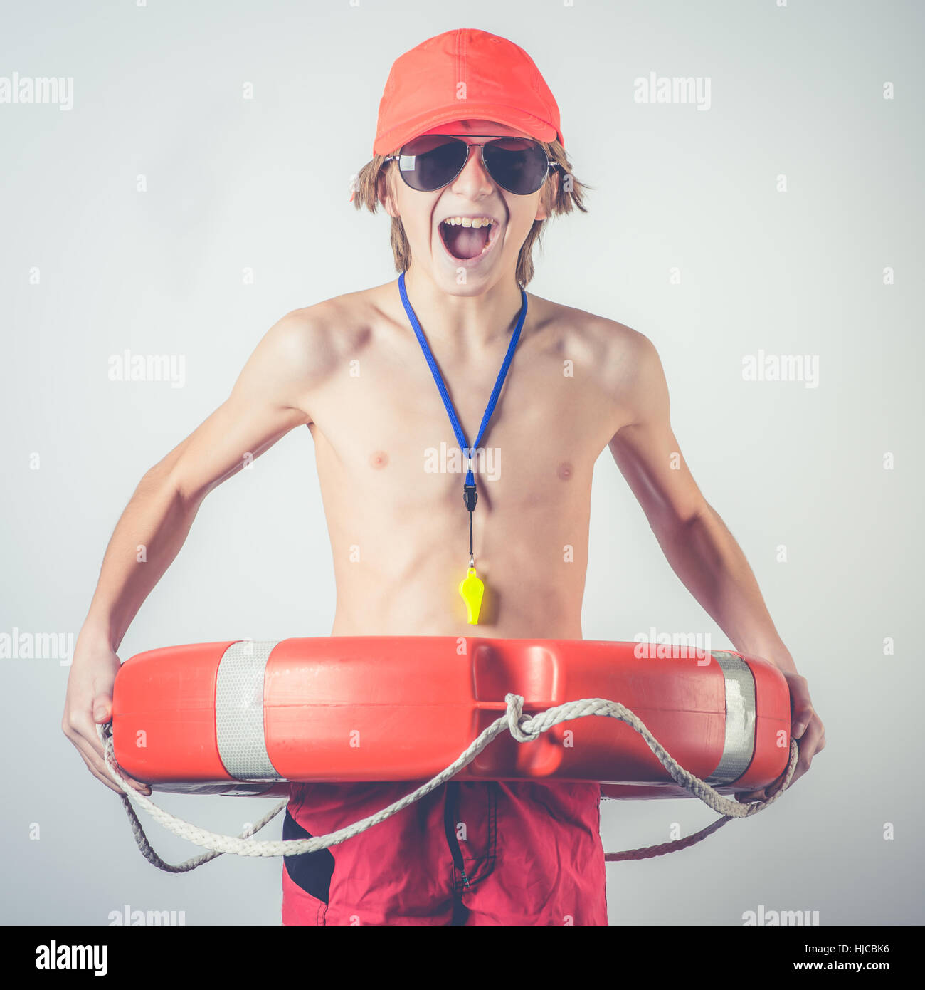 lifeguard little boy with equipment on gray background Stock Photo - Alamy