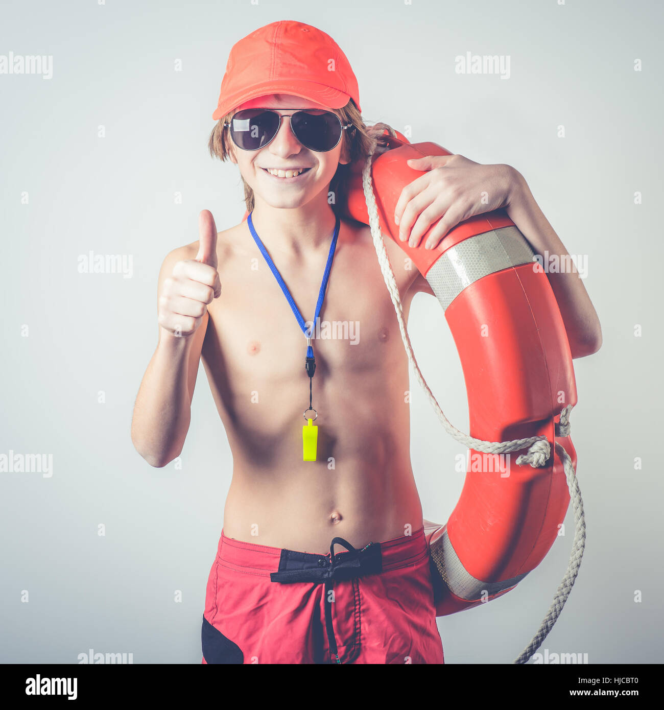 lifeguard little boy with equipment on gray background Stock Photo - Alamy