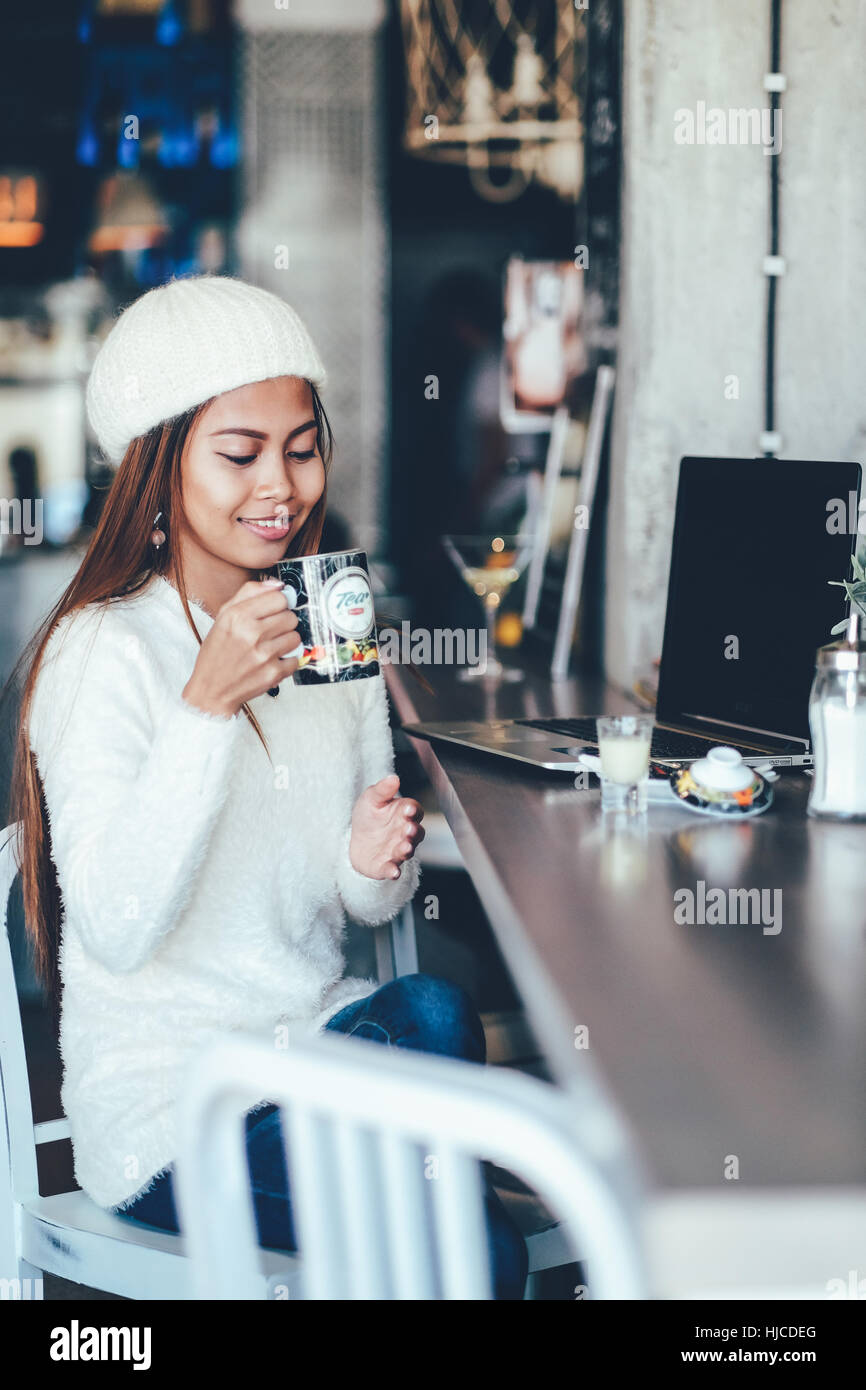 Gorgeous young woman drinking tea in cafe Stock Photo - Alamy