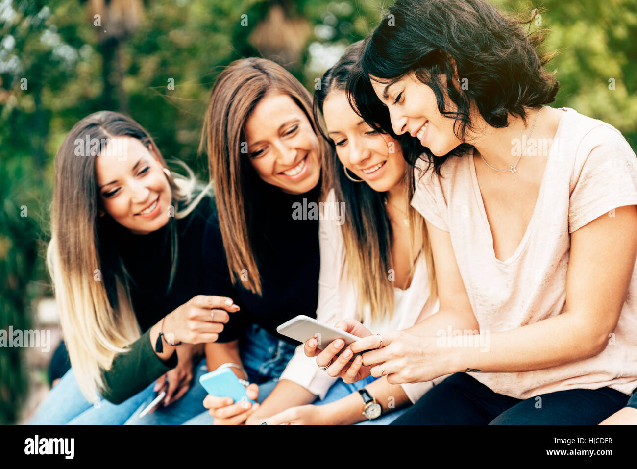 Big Group of friends using cellphones in the street Stock Photo - Alamy