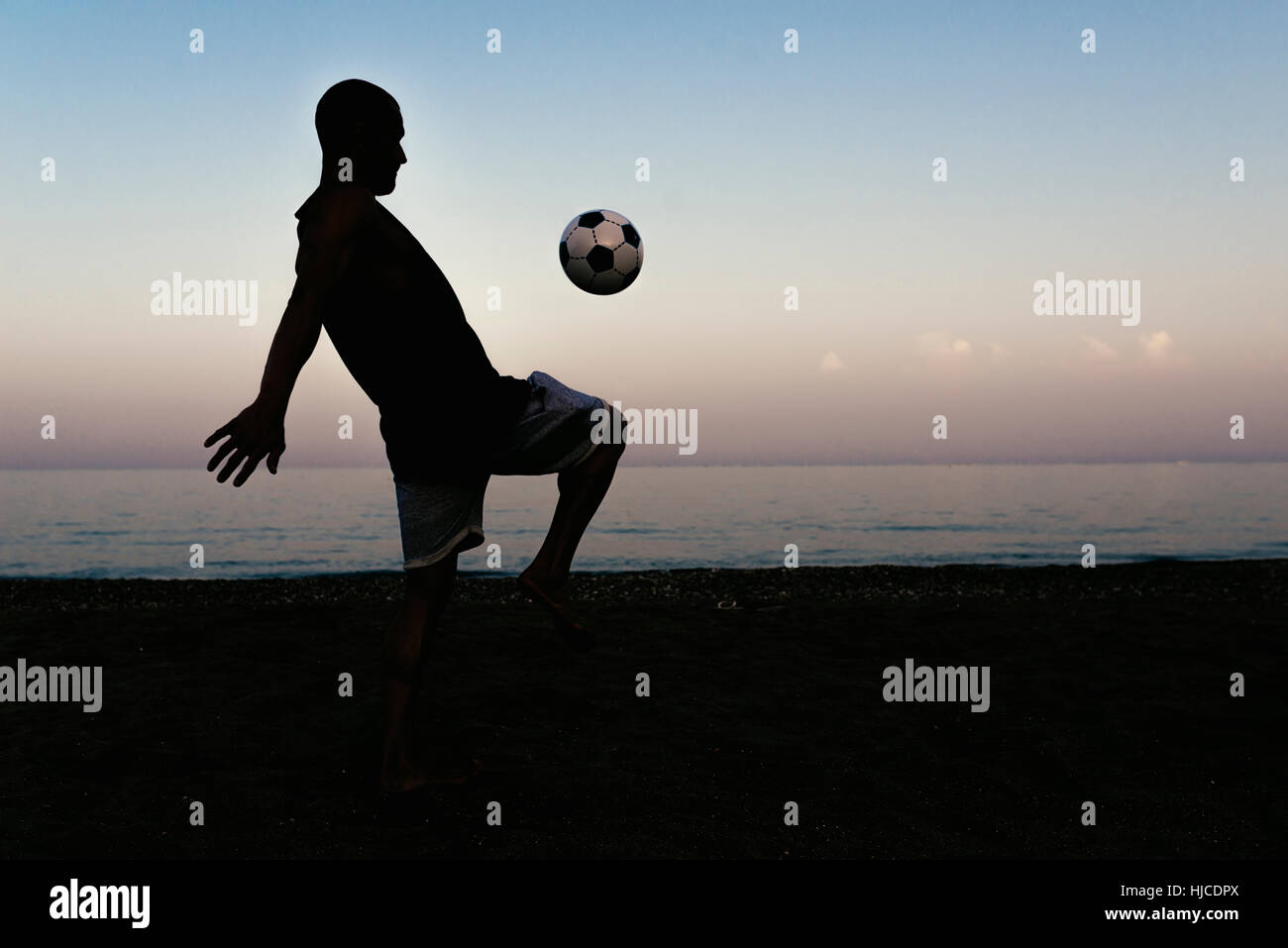 Two friends playing soccer in the beach Stock Photo - Alamy