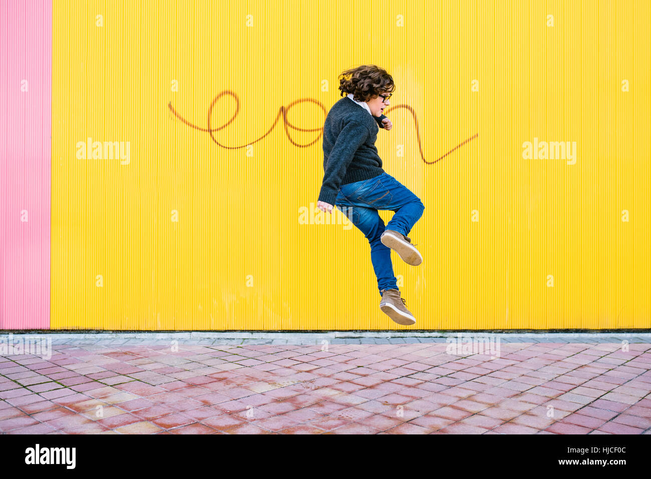 Happy boy jumping in the street Stock Photo - Alamy