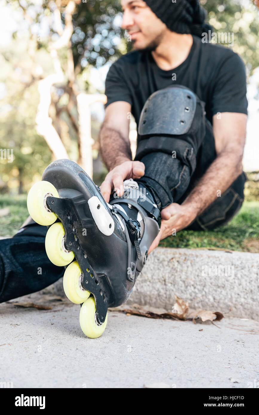 Urban young man roller sitting on the floor. Roller Concept Stock Photo ...