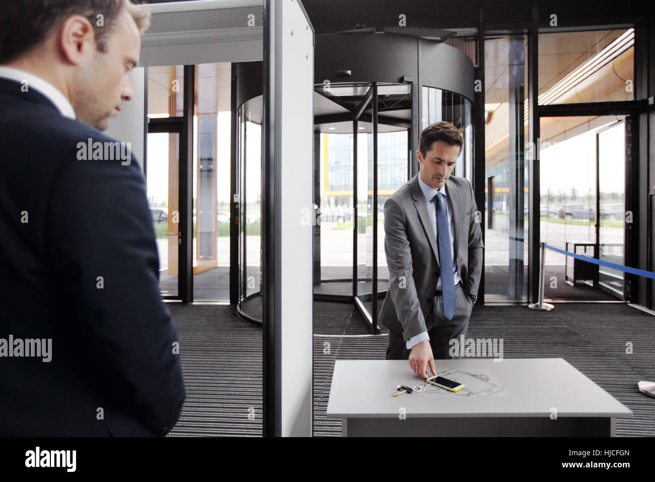 Security guard controlling indoor entrance gate Stock Photo - Alamy