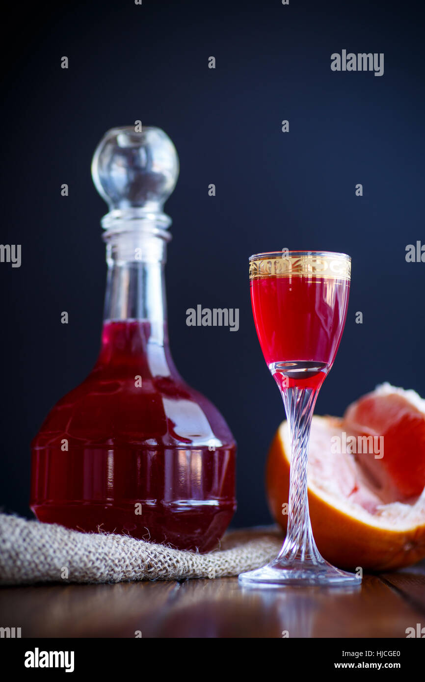 sweet grapefruit alcoholic cordial in the decanter with a glass Stock ...