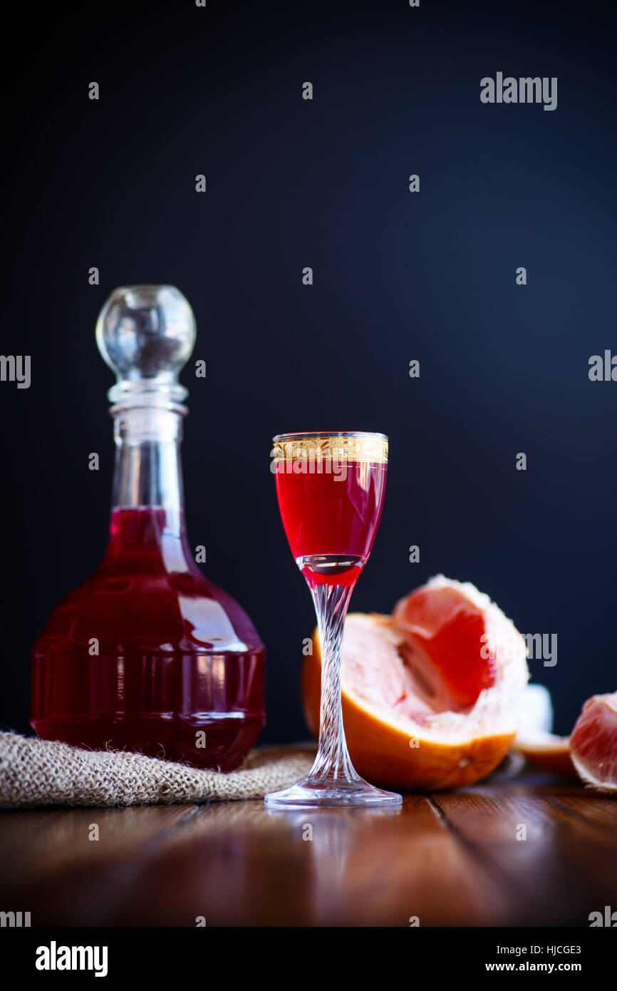 sweet grapefruit alcoholic cordial in the decanter with a glass Stock ...