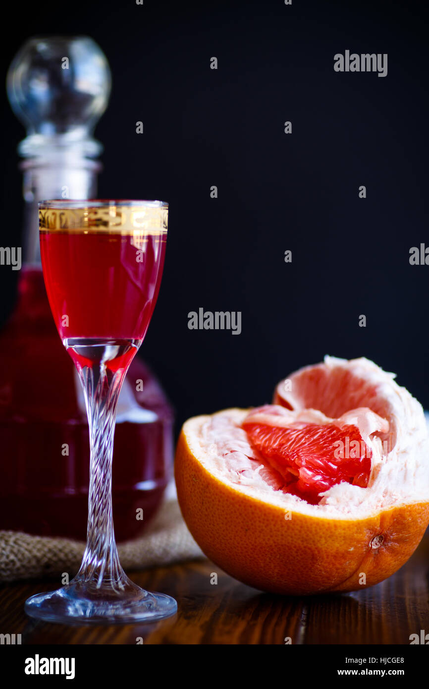 sweet grapefruit alcoholic cordial in the decanter with a glass Stock ...