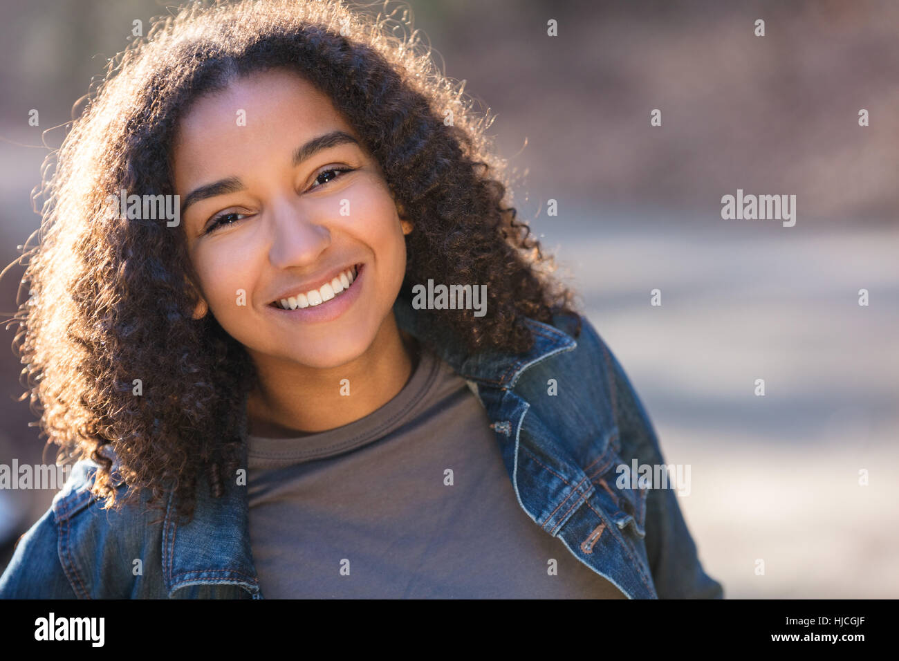 Outdoor portrait of beautiful happy mixed race African American girl ...