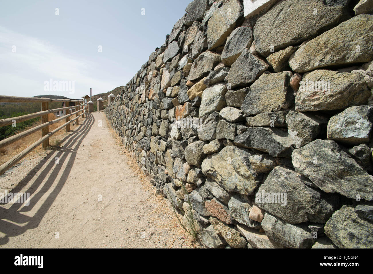a cobble wall leading to a new journey in Spain Stock Photo - Alamy