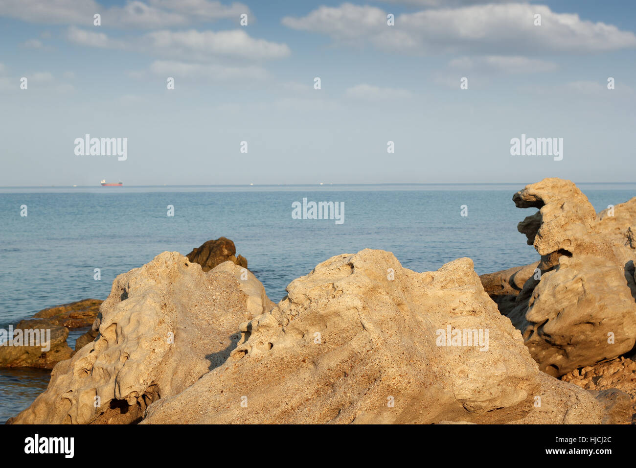 seascape with rocks and ship Stock Photo - Alamy