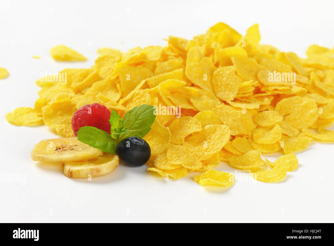 pile of corn flakes on white background - close up Stock Photo - Alamy