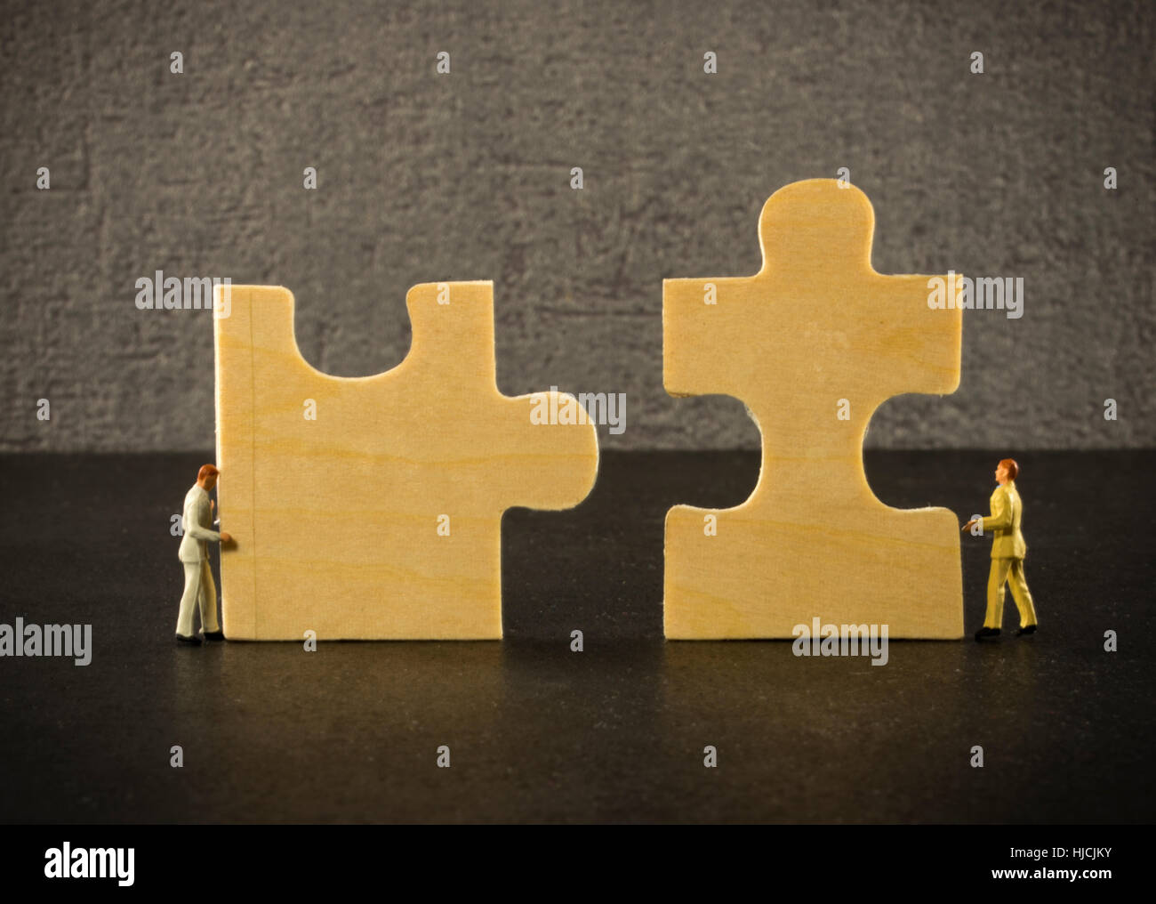 little people solving the problem with the puzzle Stock Photo - Alamy