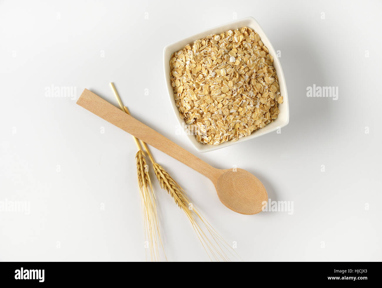 bowl of oat flakes on off-white background with shadows Stock Photo - Alamy
