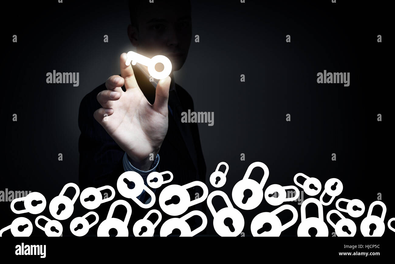 Male hand taking key glowing sign with fingers Stock Photo - Alamy