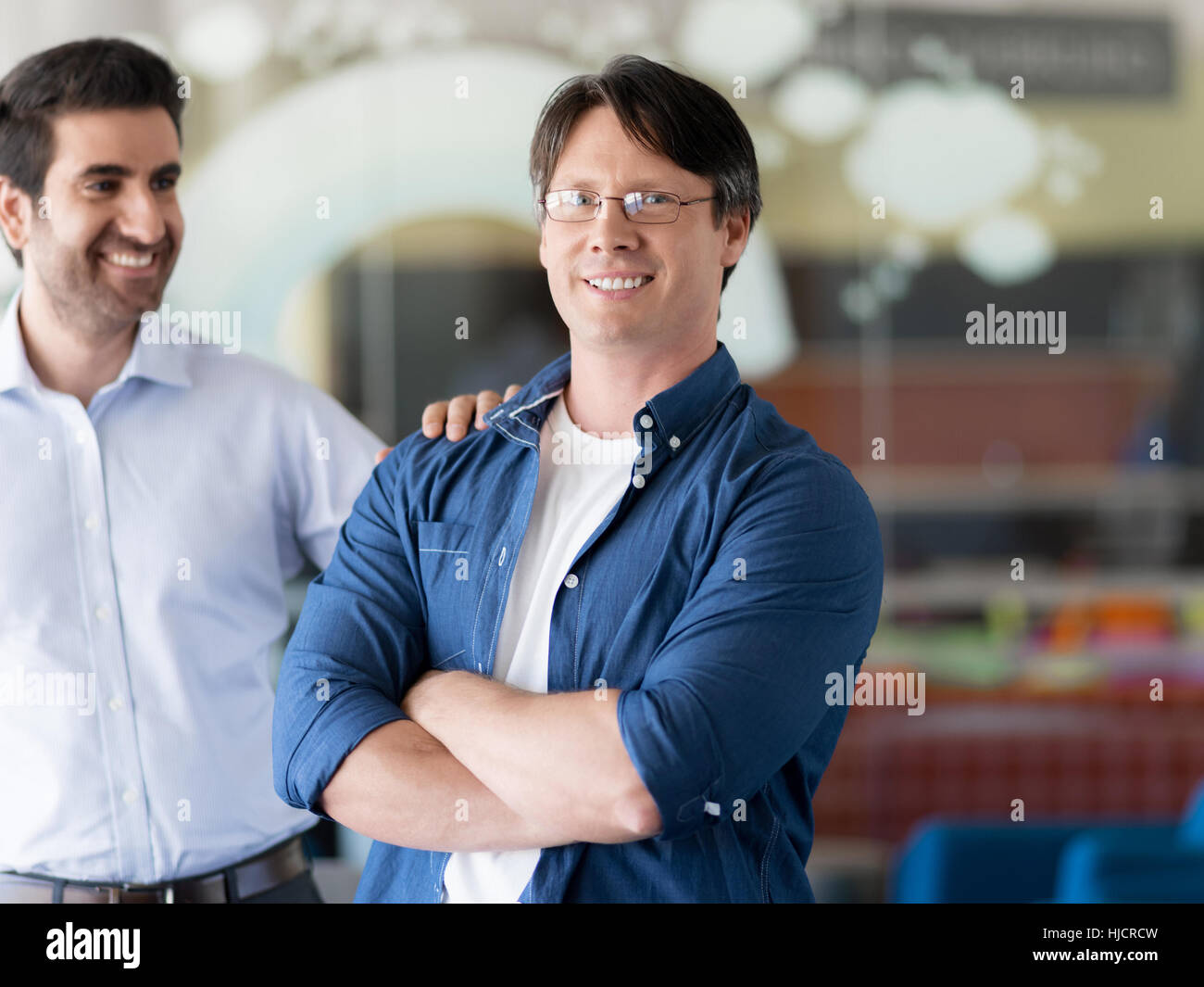 Young man standing happily hi-res stock photography and images - Alamy