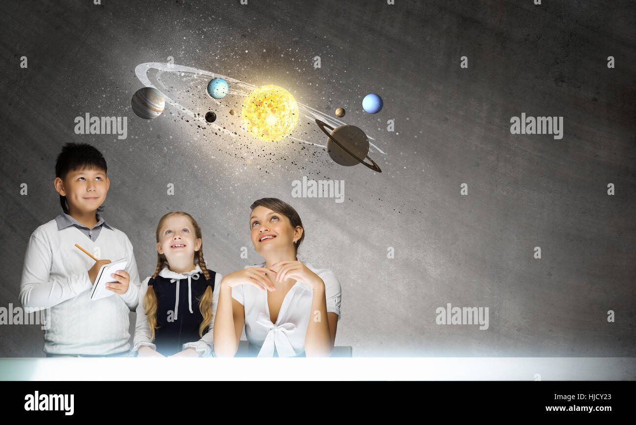 Cute boy of school age and teacher exploring space system Stock Photo ...