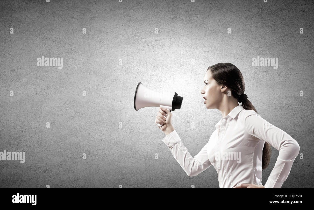 Young furious woman screaming agressively in megaphone Stock Photo - Alamy
