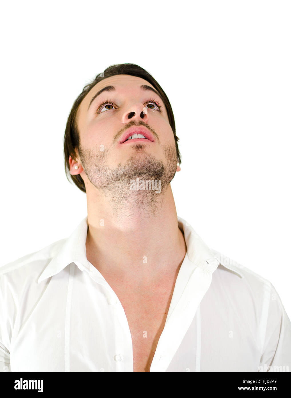 Good looking young man in shirt looking up, isolated on white ...