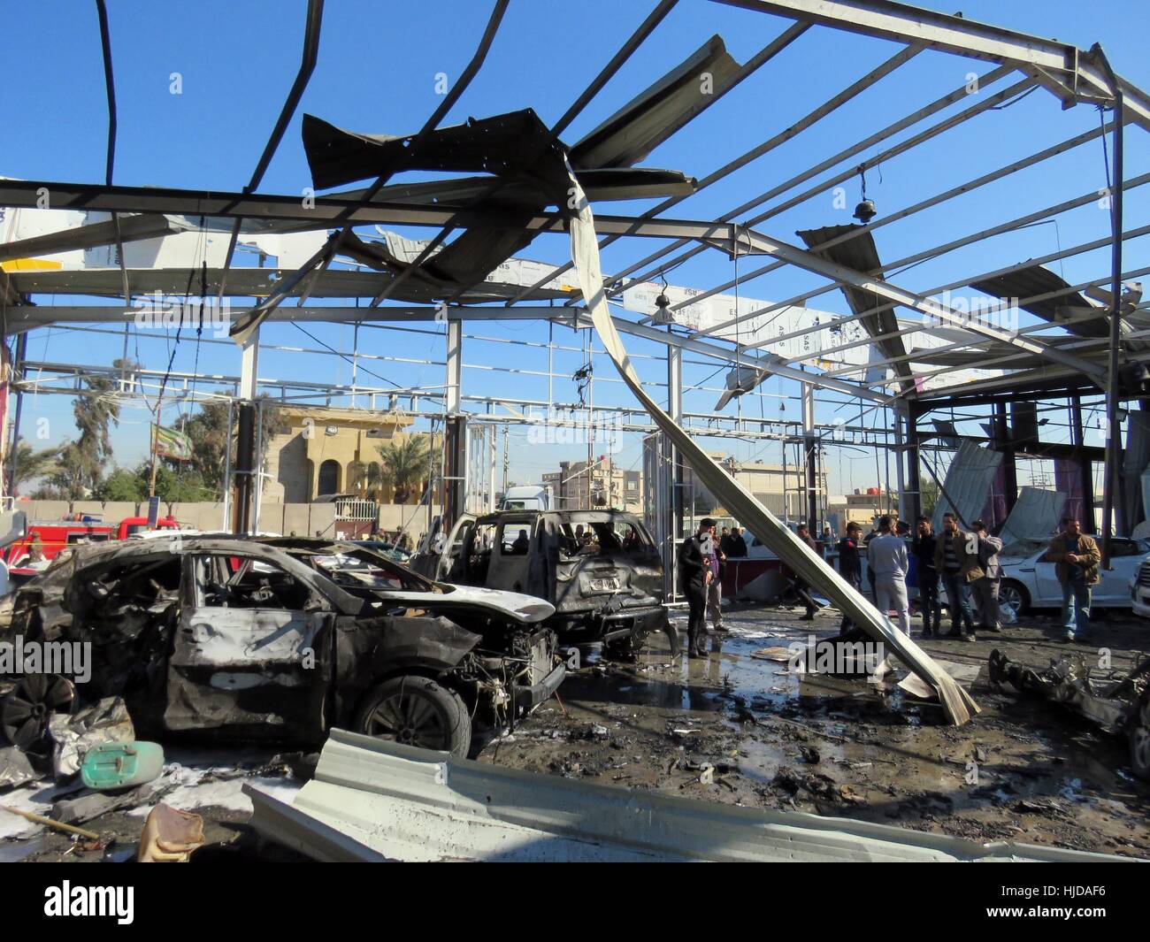 Baghdad, Iraq. 24th Jan, 2017. People gather at the site of a car bomb ...