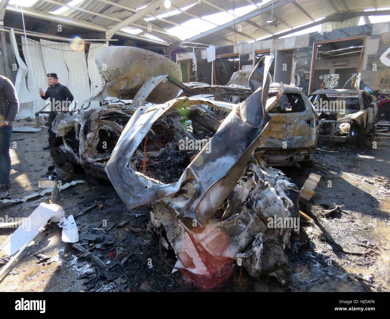 Baghdad, Iraq. 24th Jan, 2017. Destroyed vehicles are seen at the site ...