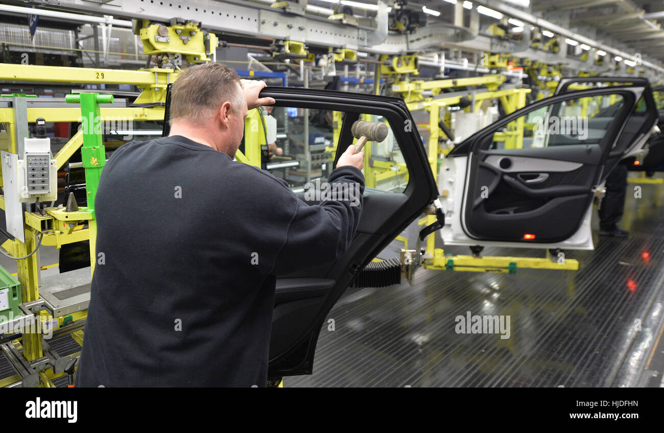 An employee works on a C-Class at the Mercedes Benz manufactory in ...