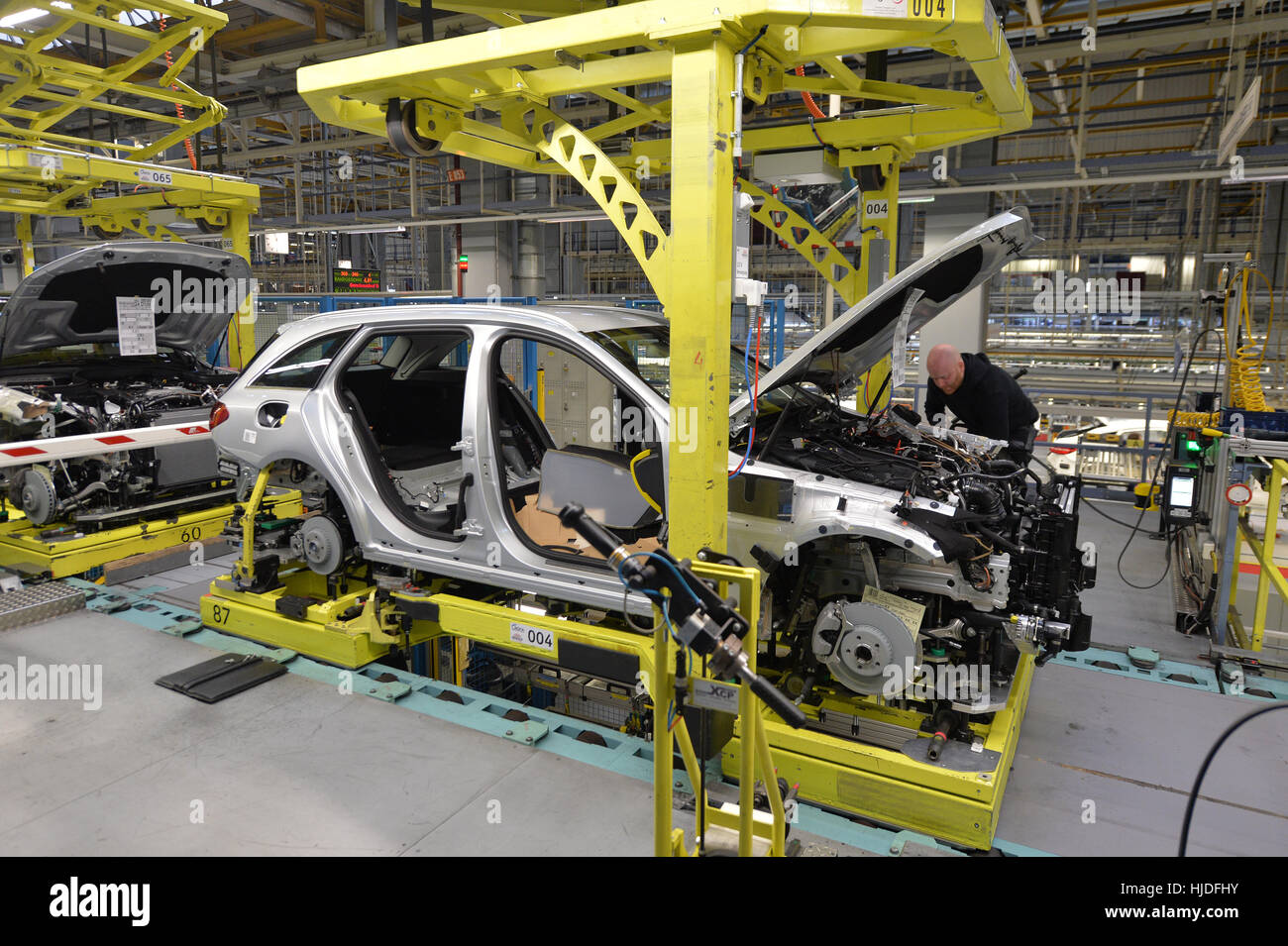 An employee works on a C-Class at the Mercedes Benz manufactory in ...