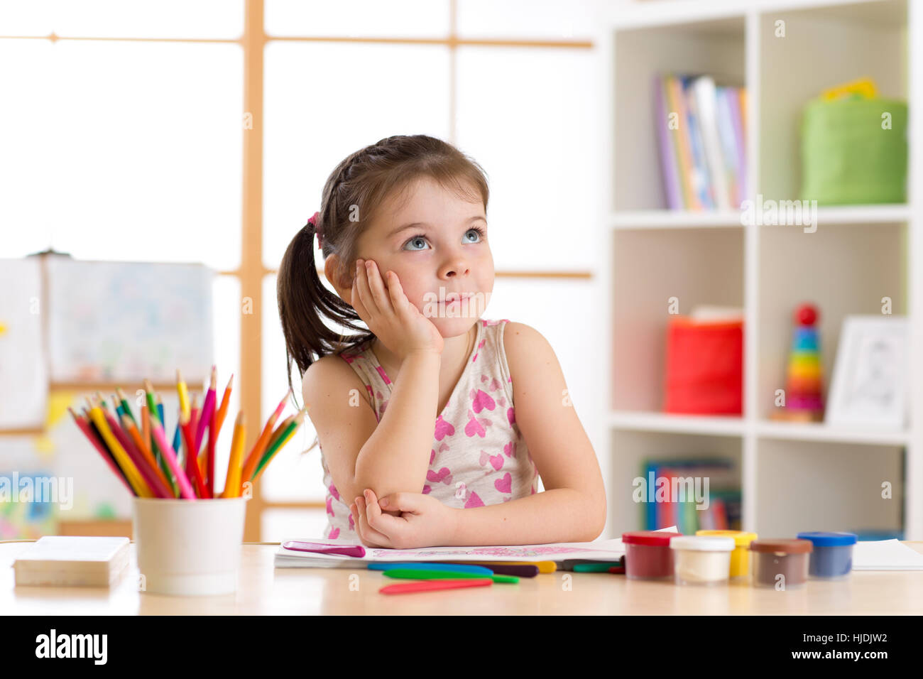 dreamy child girl drawing with color pencils Stock Photo - Alamy
