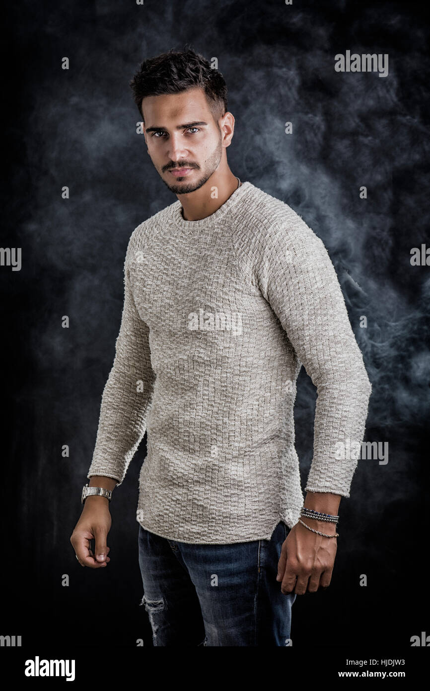 Handsome young man wearing white sweater Stock Photo - Alamy