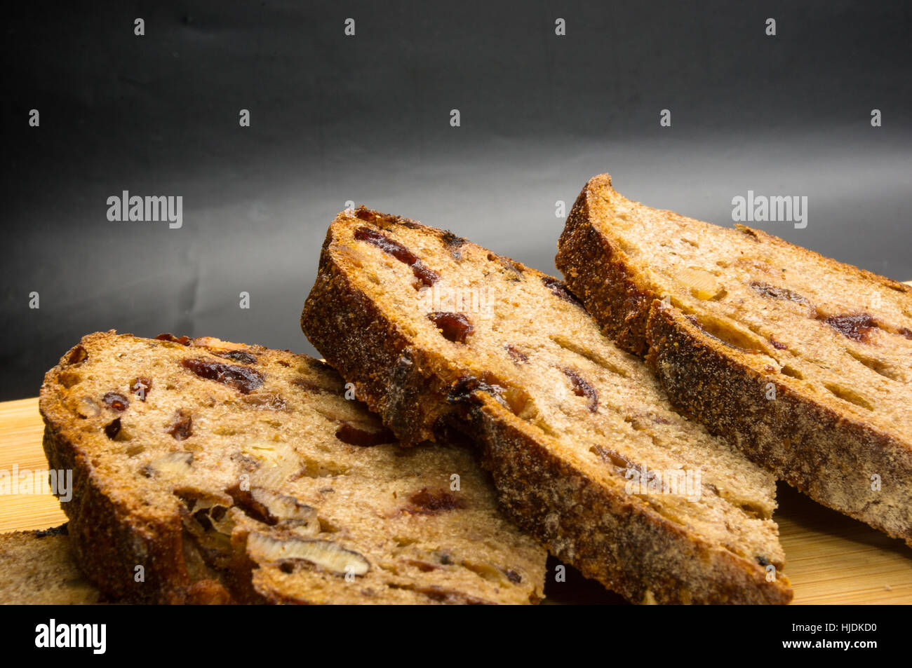 Slices of malt bread handmade with nuts, raisins and cranberries on ...