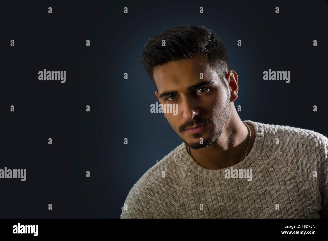 Handsome young man wearing white sweater Stock Photo - Alamy