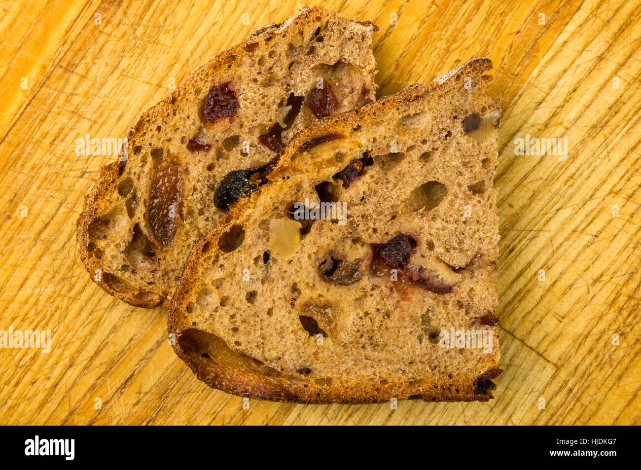Slices of malt bread handmade with nuts, raisins and cranberries on ...