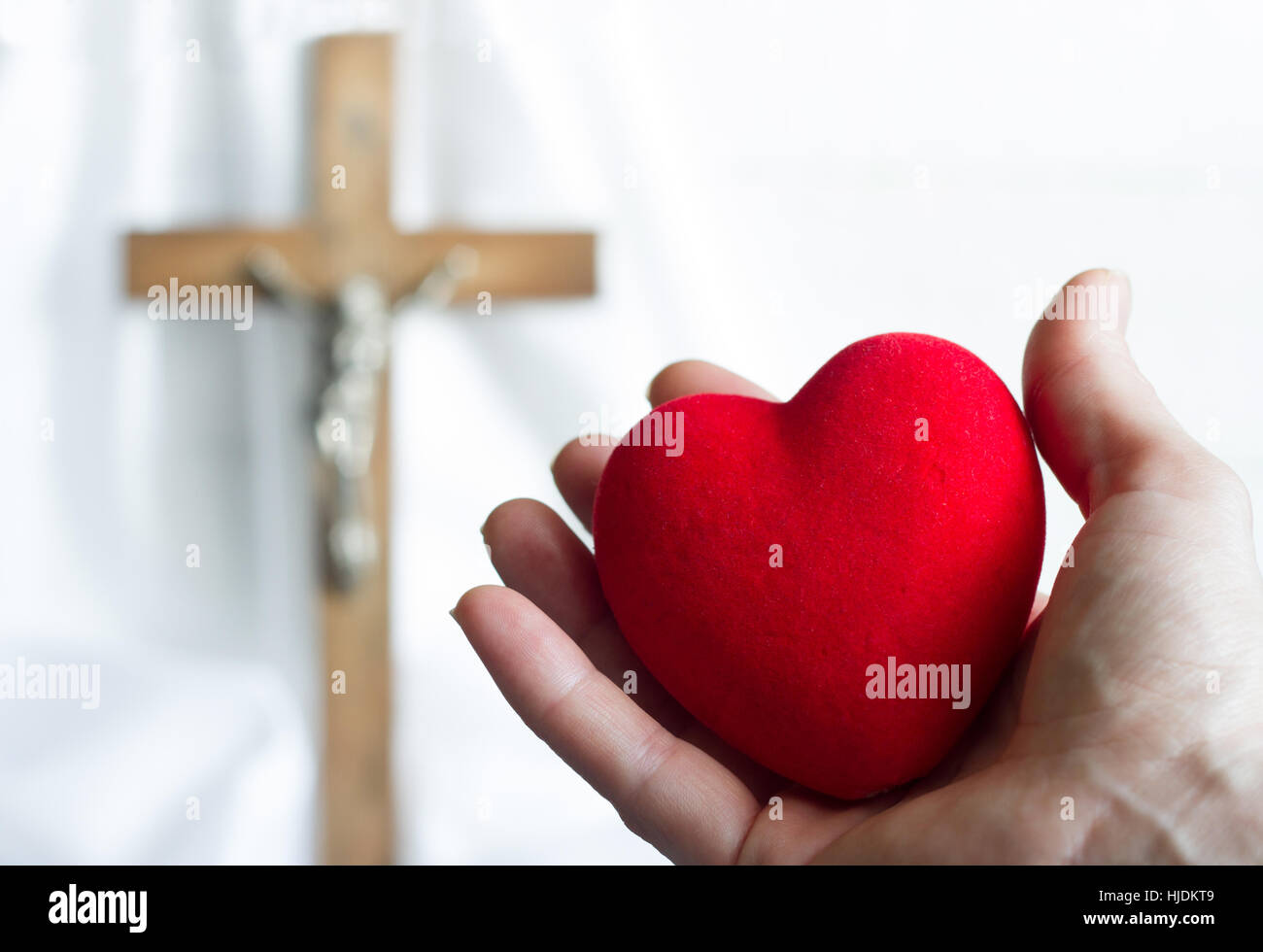 Giving heart to Jesus abstract concept with easter cross on a white ...